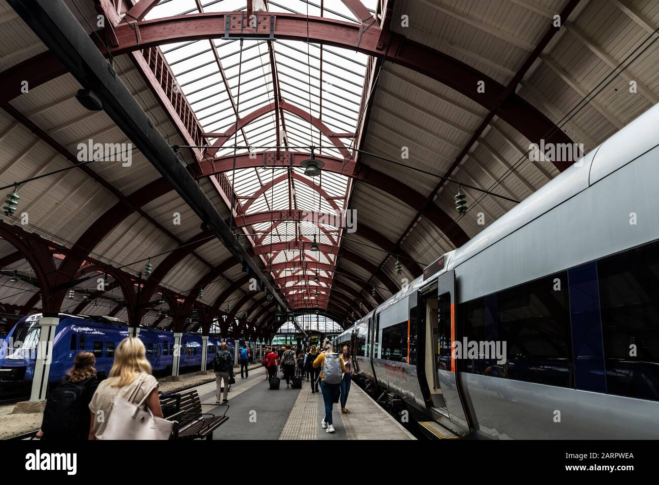Malmo, Sweden - August 30, 2019: Trains and people inside the Central ...