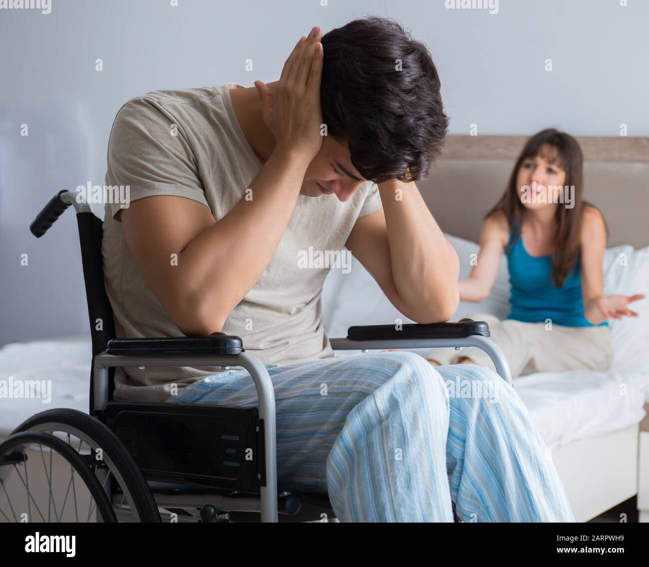 The desperate man on wheelchair with his sad wife Stock Photo - Alamy