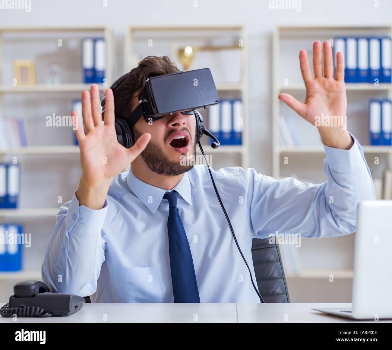 The businessman gamer in office playing games Stock Photo - Alamy