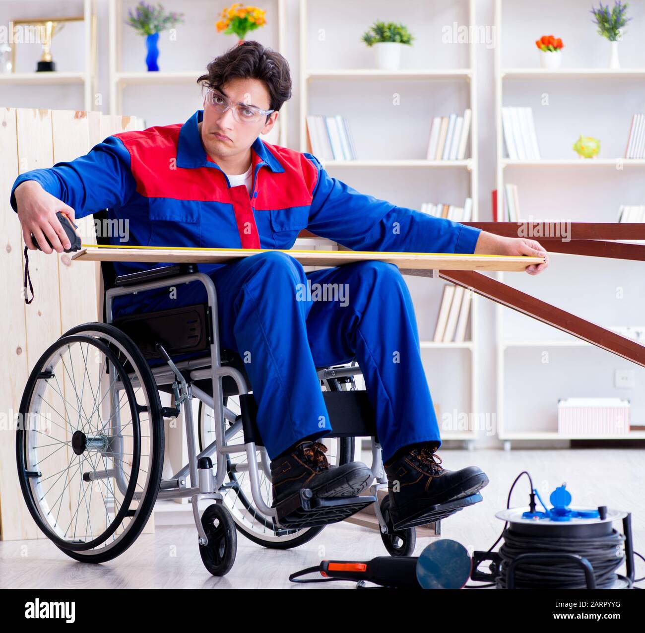 The disabled carpenter taking measurement in workshop Stock Photo - Alamy
