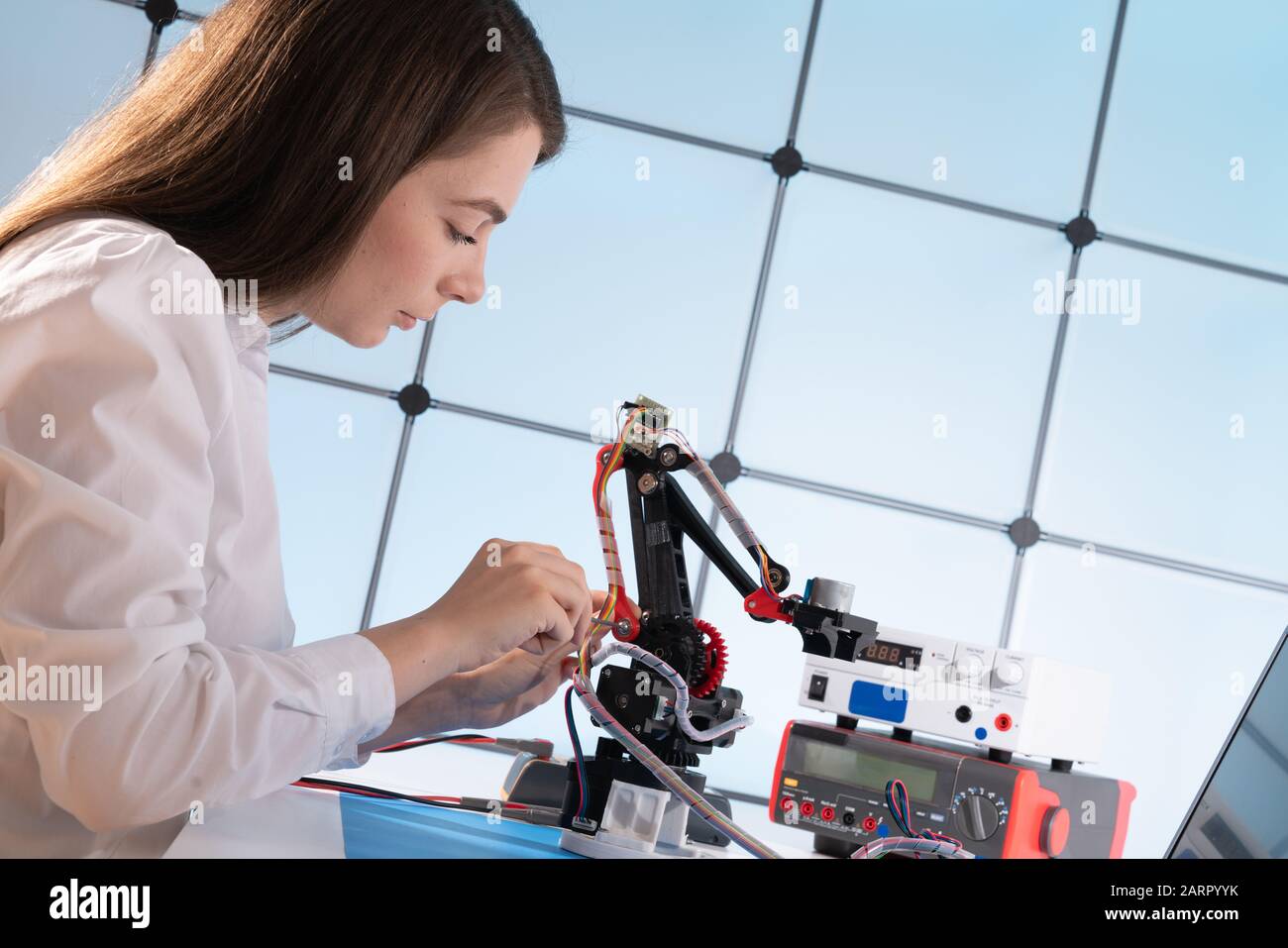 Woman student with industrial robot arm in designer laboratory Stock Photo - Alamy