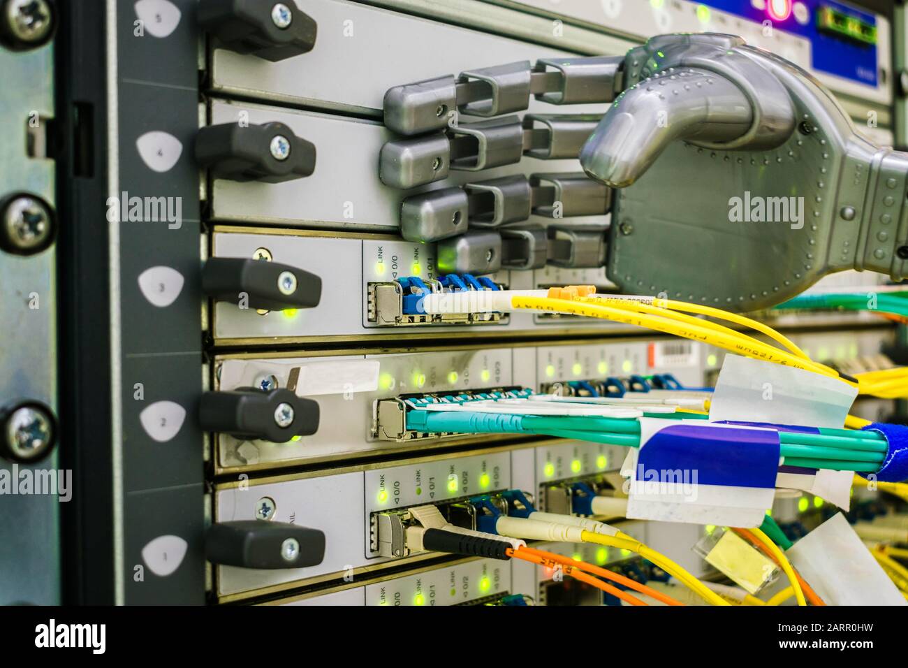 The robot's hand is located near the Internet router with a lot of ...