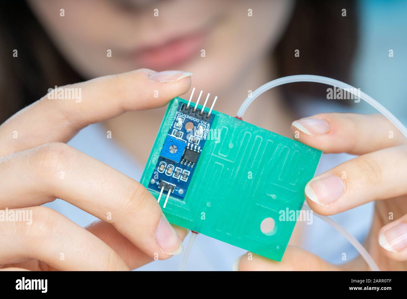 Young scientist woman in microbiological lab with lab-on-chip LOC ...