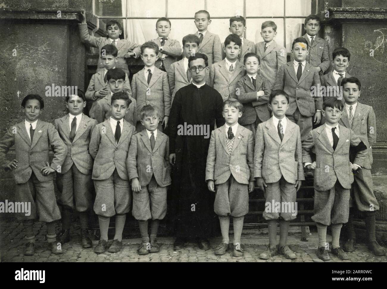 School photo with the teacher priest, Italy 1920s Stock Photo - Alamy