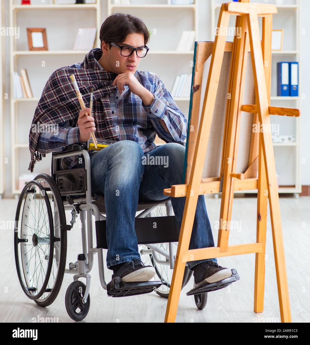 The disabled artist painting picture in studio Stock Photo - Alamy