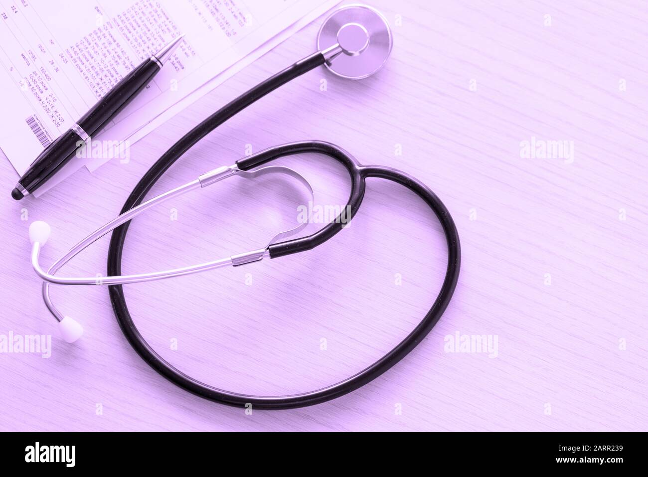 Stethoscope and medical documents on doctor table on purple background ...