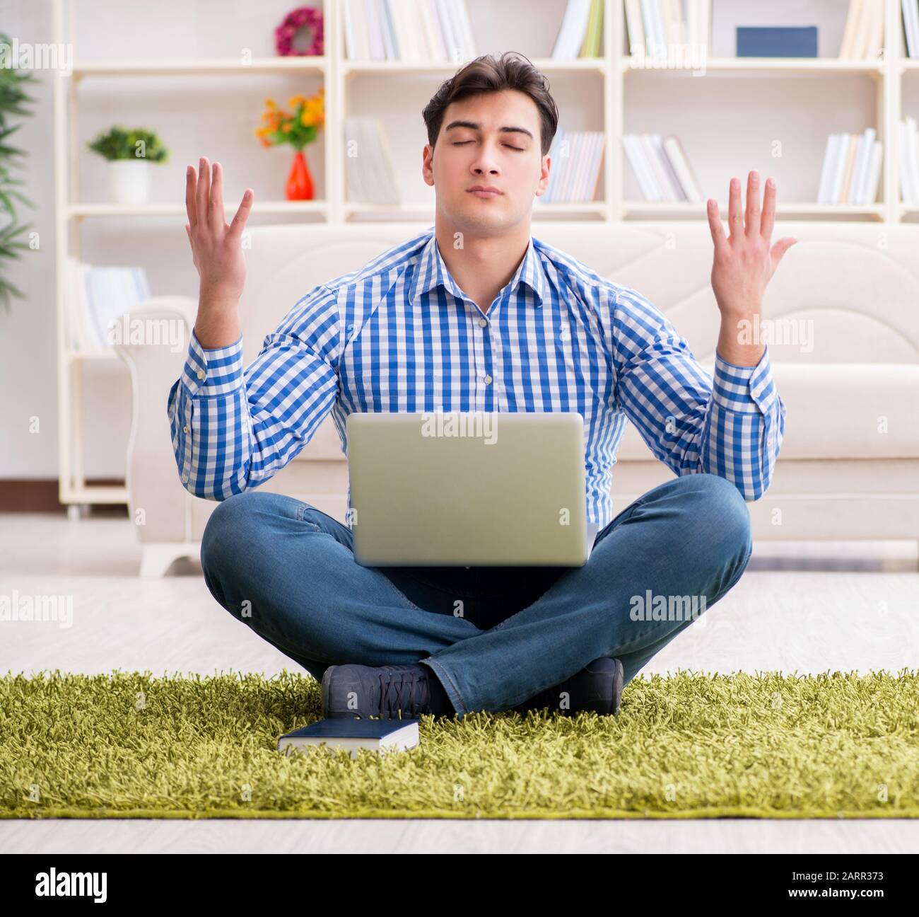 The young handsome man sitting on floor at home Stock Photo - Alamy