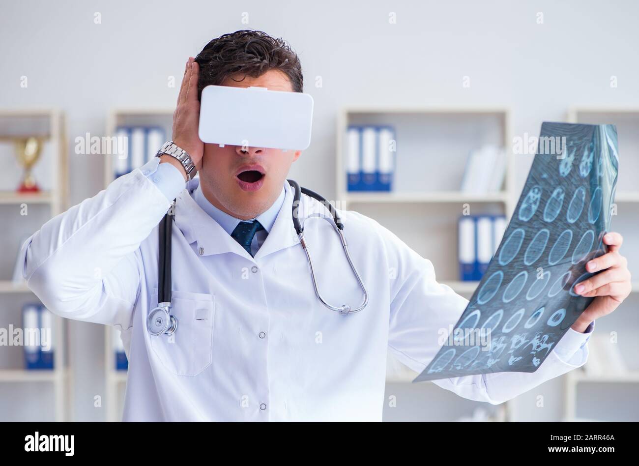 The young doctor looking at mri scan through vr glasses Stock Photo - Alamy