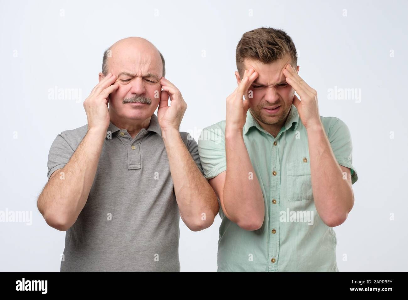 Negative human facial expressions and emotions. Displeased men keep ...