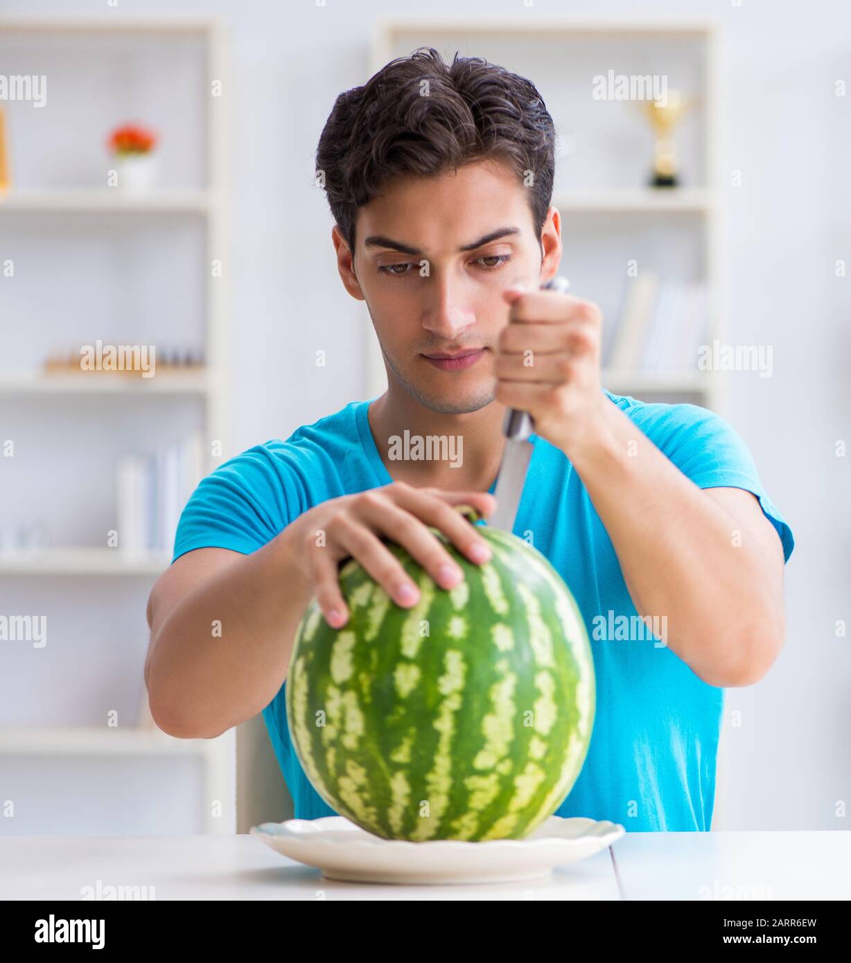 The man eating watermelon at home Stock Photo - Alamy