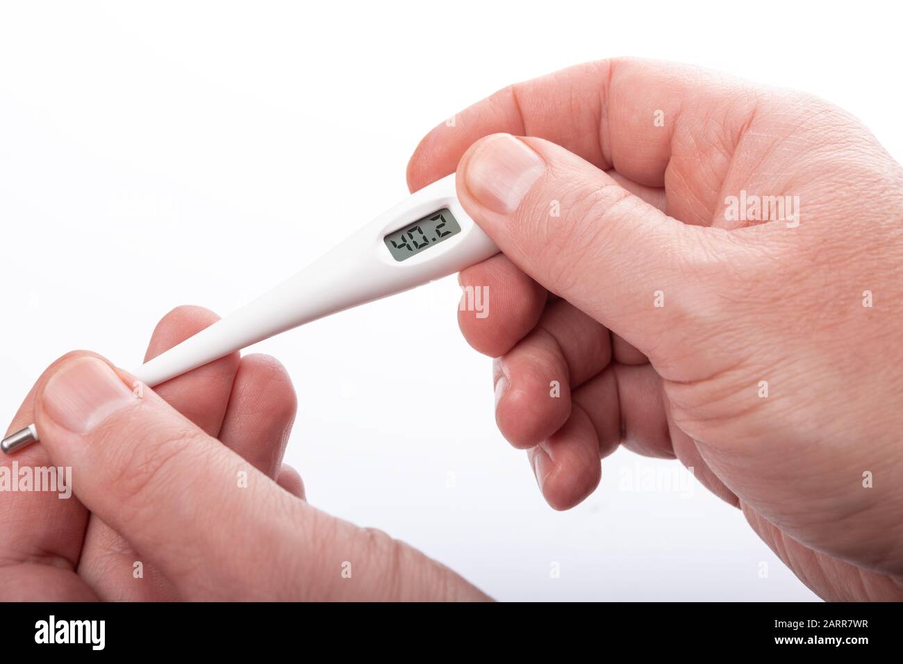 Man`s hands holding white electronic thermometer indicating high ...