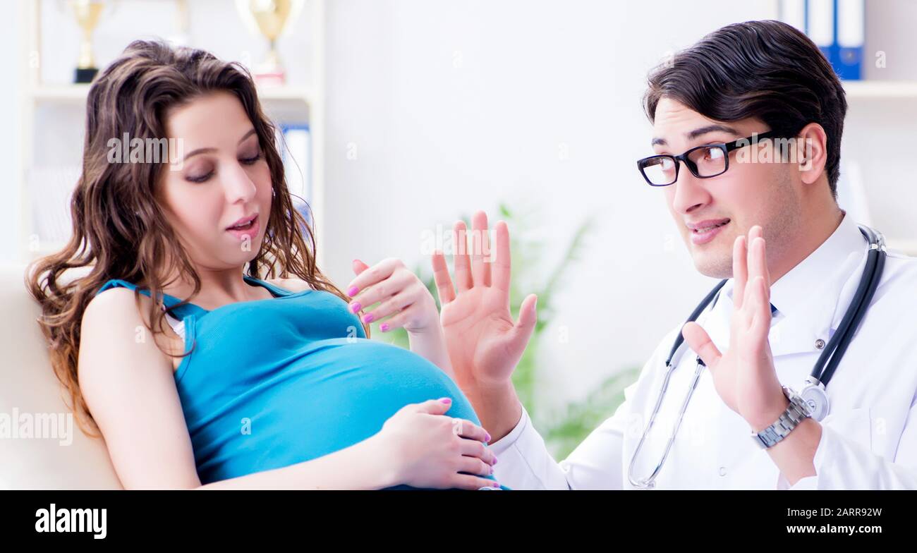 The doctor examining pregnant female patient in hospital Stock Photo ...