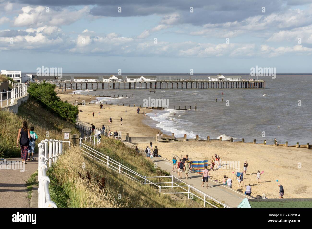 Beach scene, with the pier in the distance, in the resort of Southwold ...