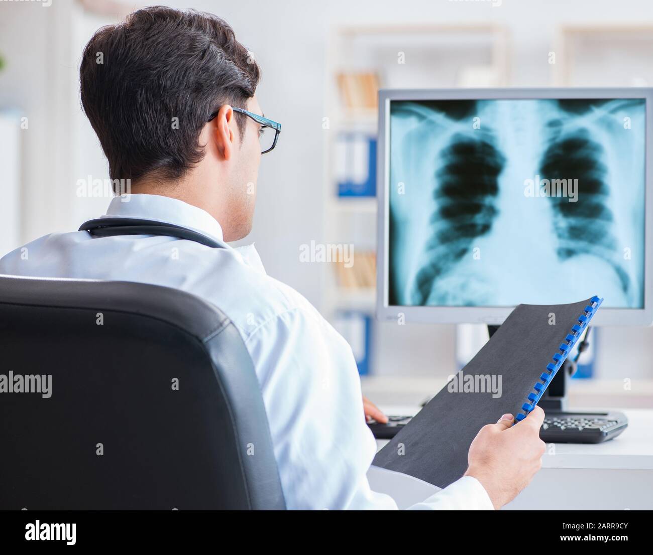 Doctor radiologist looking at x-ray images Stock Photo - Alamy