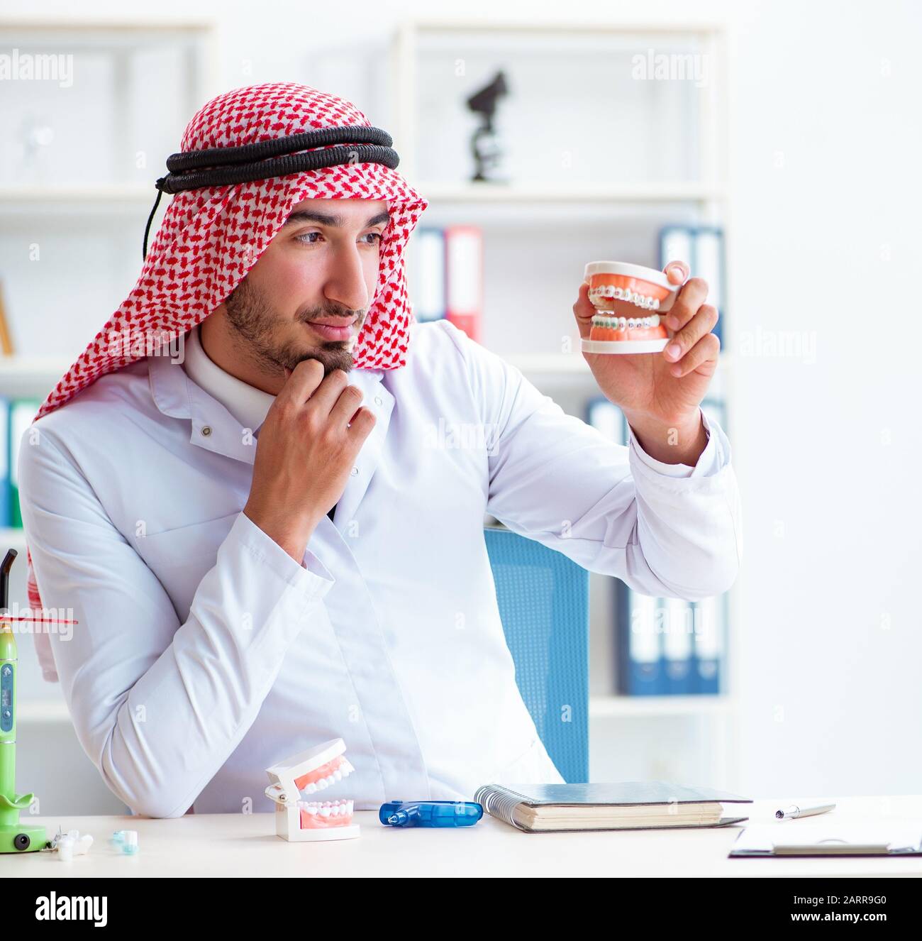 The arab dentist working on new teeth implant Stock Photo - Alamy