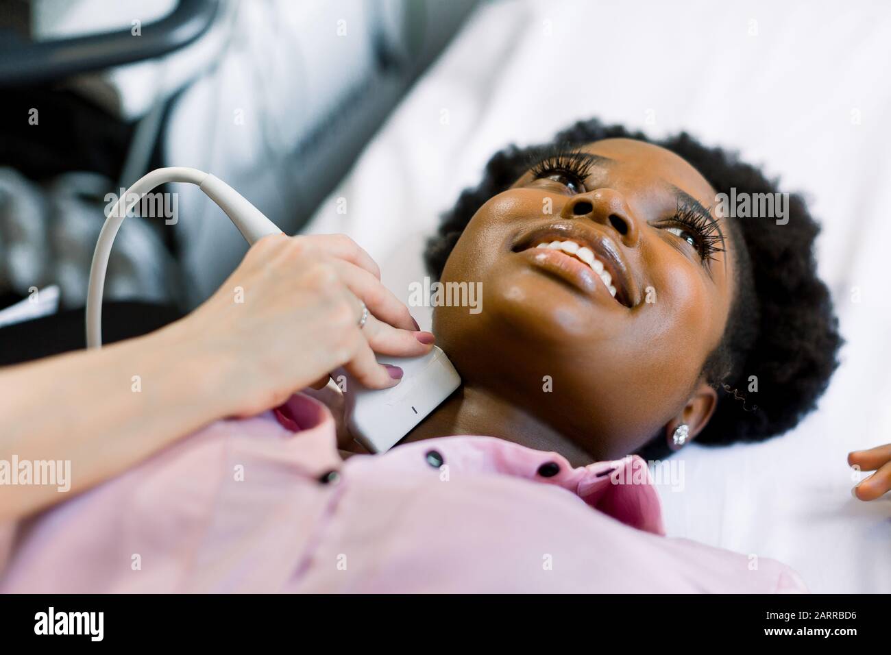 Close Up Shot Of A Young Smiling African American Woman Getting Her Neck And Thyroid Gland