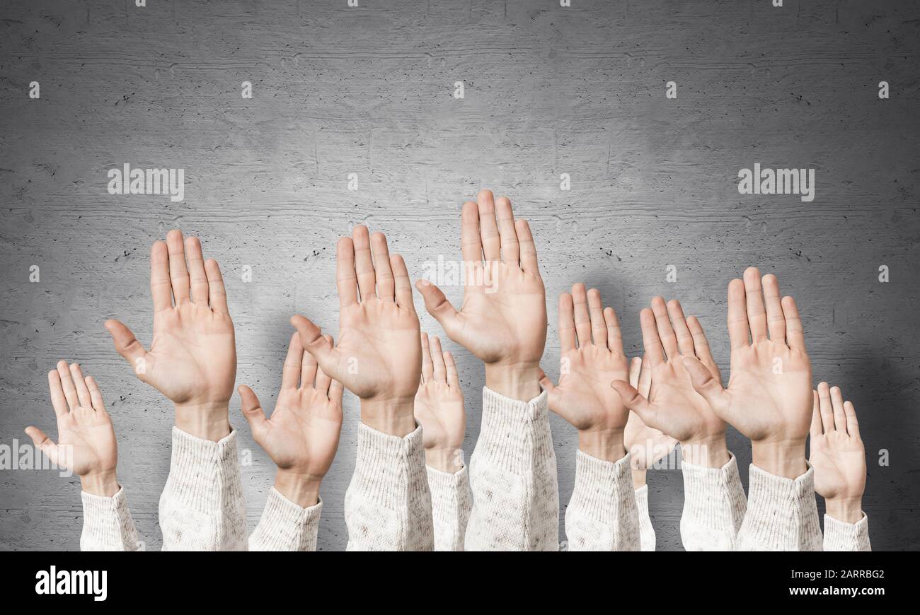 Row of man hands showing voting gesture Stock Photo - Alamy