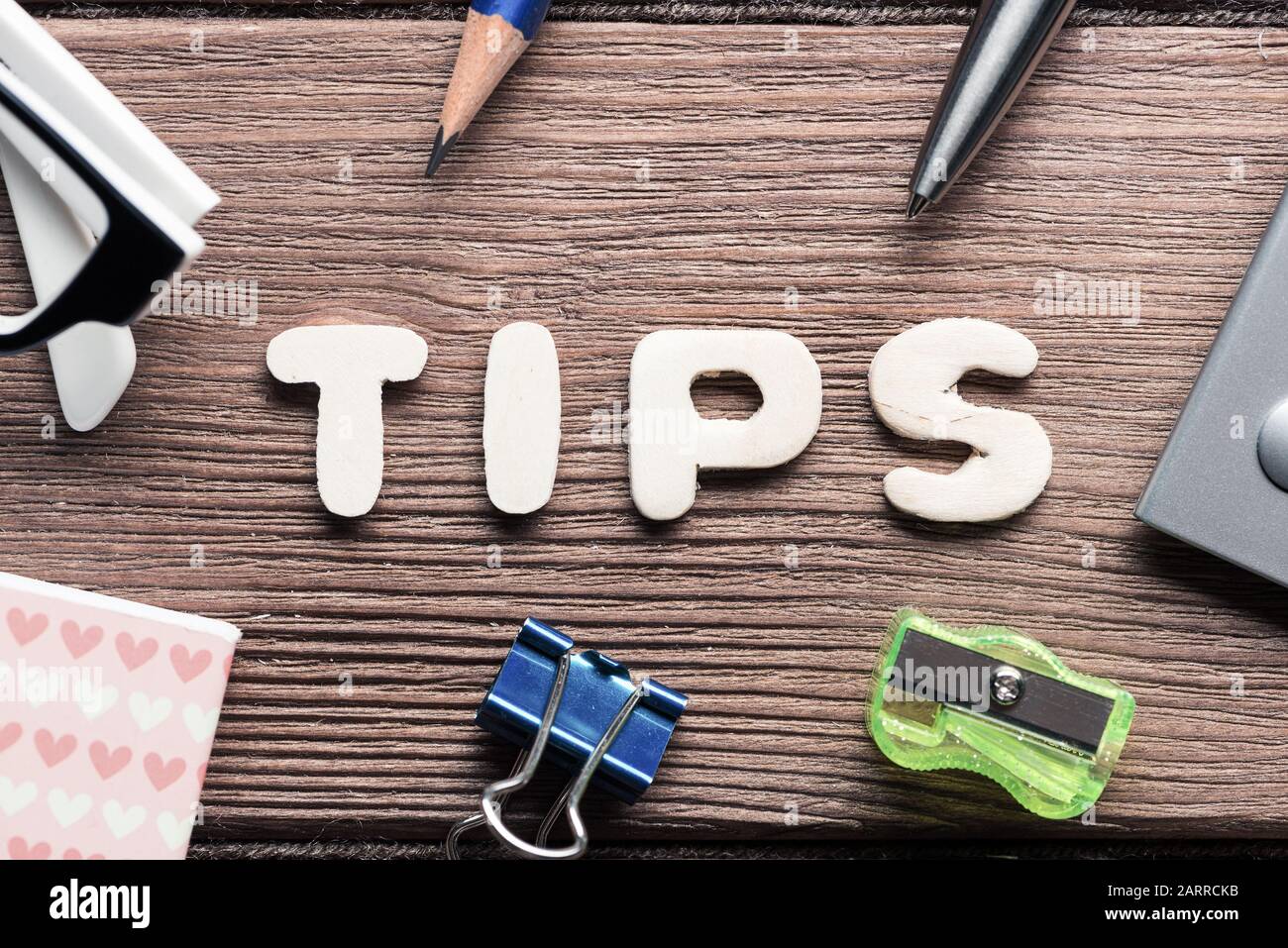 Tips word on wooden table and office stationary around Stock Photo - Alamy