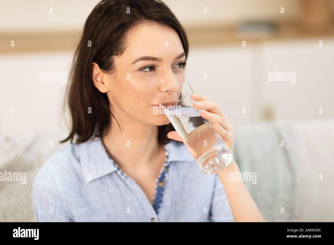 Smiling girl drinking clean water from glass Stock Photo - Alamy
