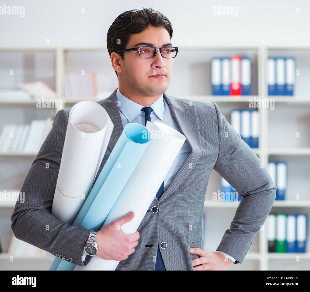 The businessman engineer draftsman with blueprints drawings Stock Photo ...