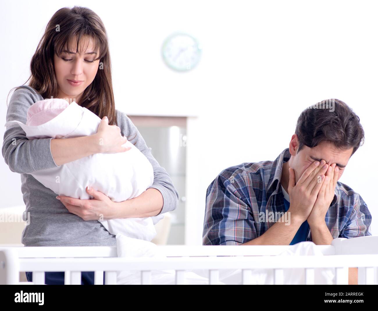 The young dad cannot stand baby crying Stock Photo - Alamy