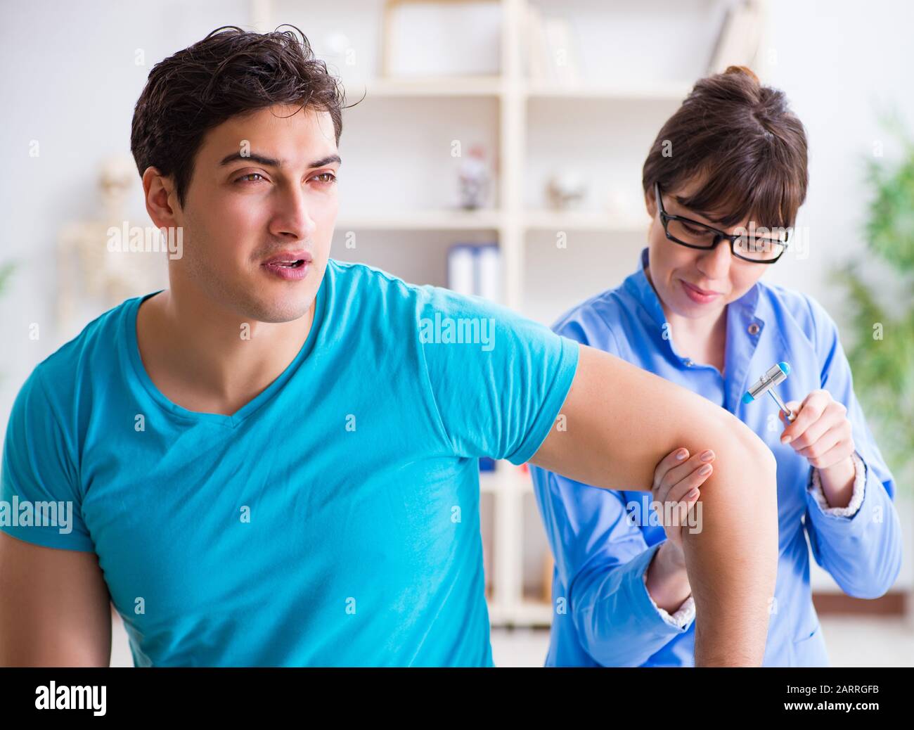 The doctor checking nerve reflexes with hammer Stock Photo - Alamy