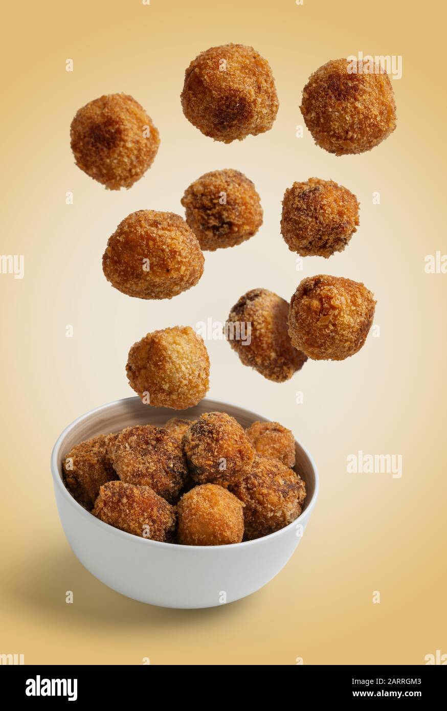 Homemade croquettes flying isolated from cream colored background Stock ...