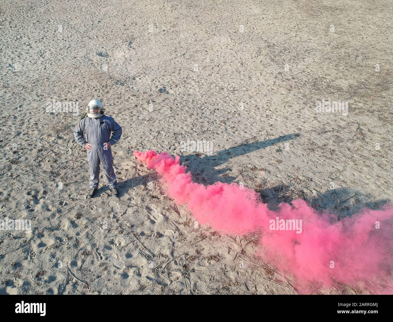 downed pilot signaling for rescue with smoke bomb in desert area Stock ...