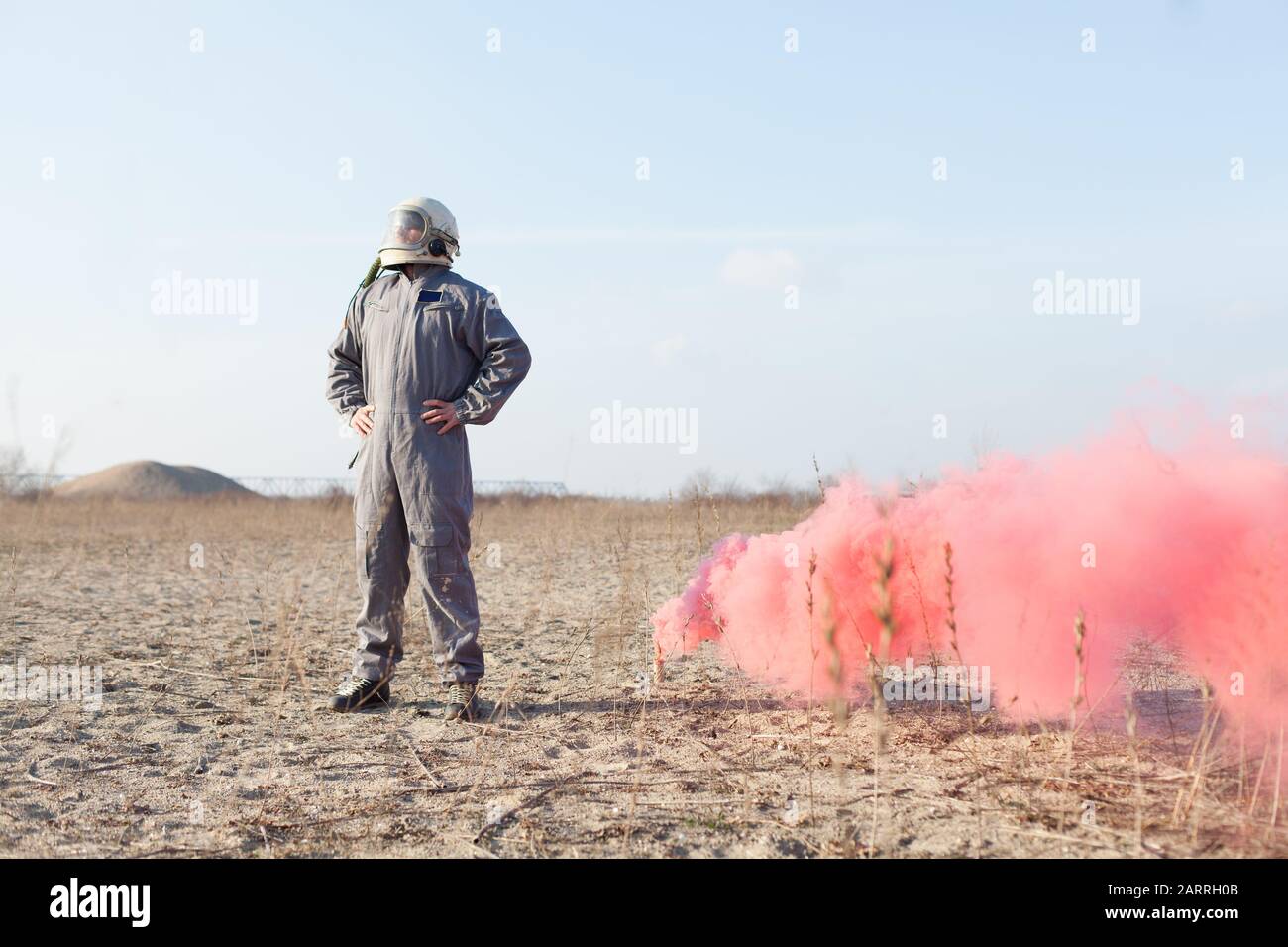 downed pilot signaling for rescue with smoke bomb in desert area Stock ...