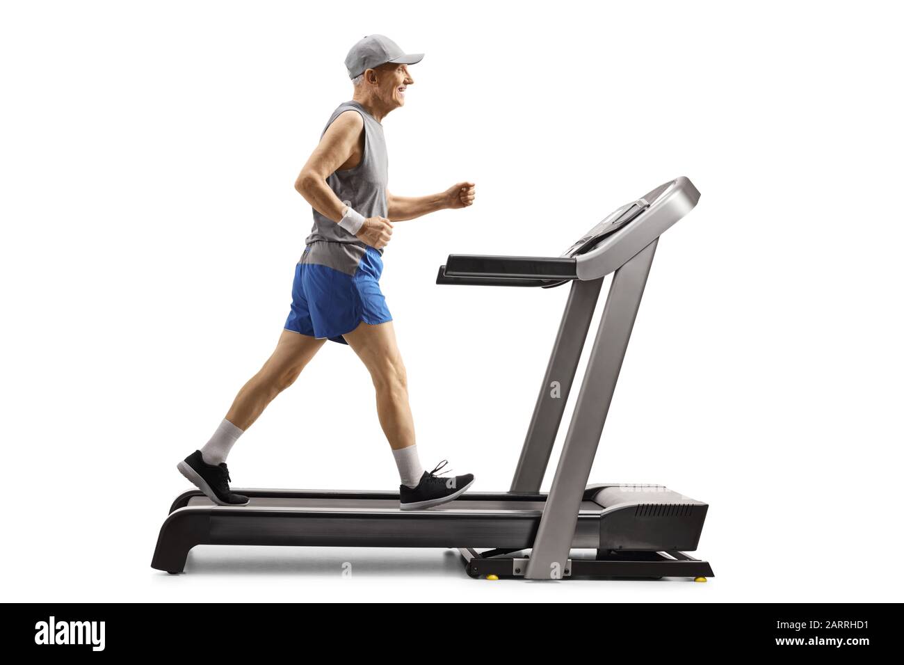 Full length profile shot of an active senior man walking on a treadmill ...