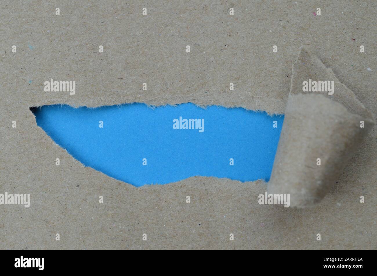 ripped paper revealing blue blank space for words conceptional for things that you can discover ...