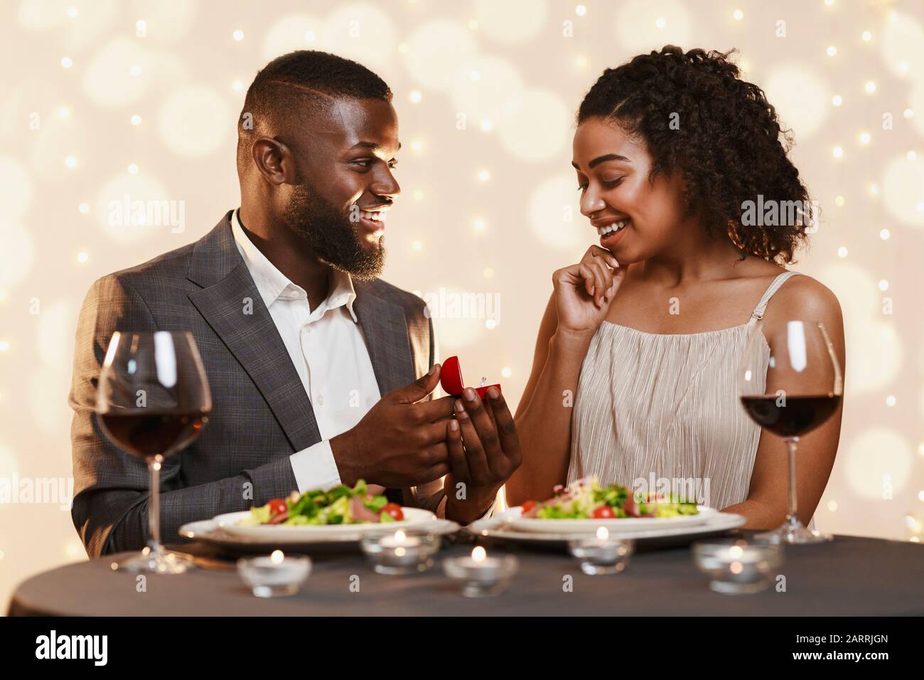 Handsome black man making marriage proposal to his beautiful woman ...