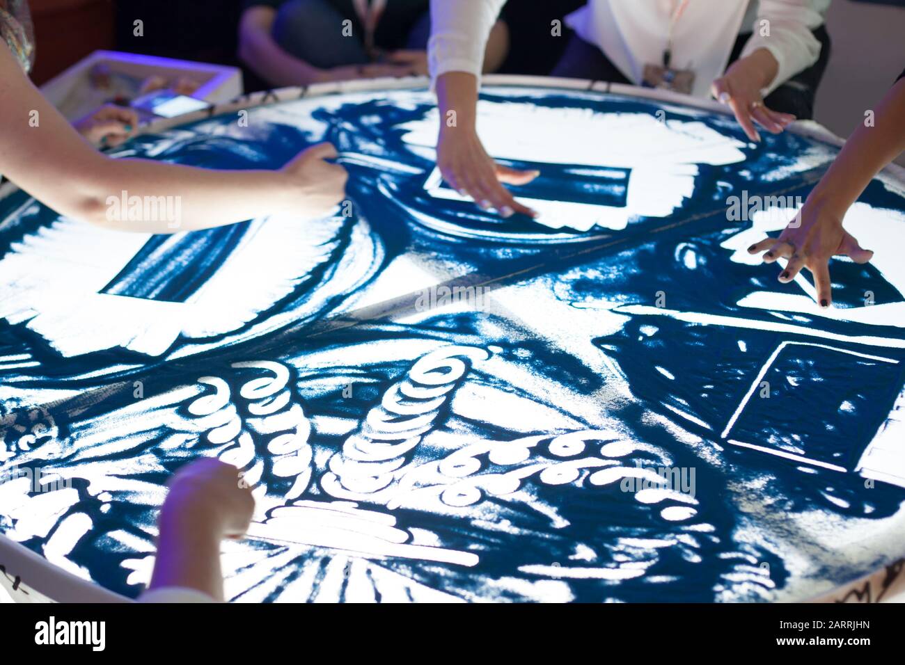 sand art therapy session with many people Stock Photo - Alamy