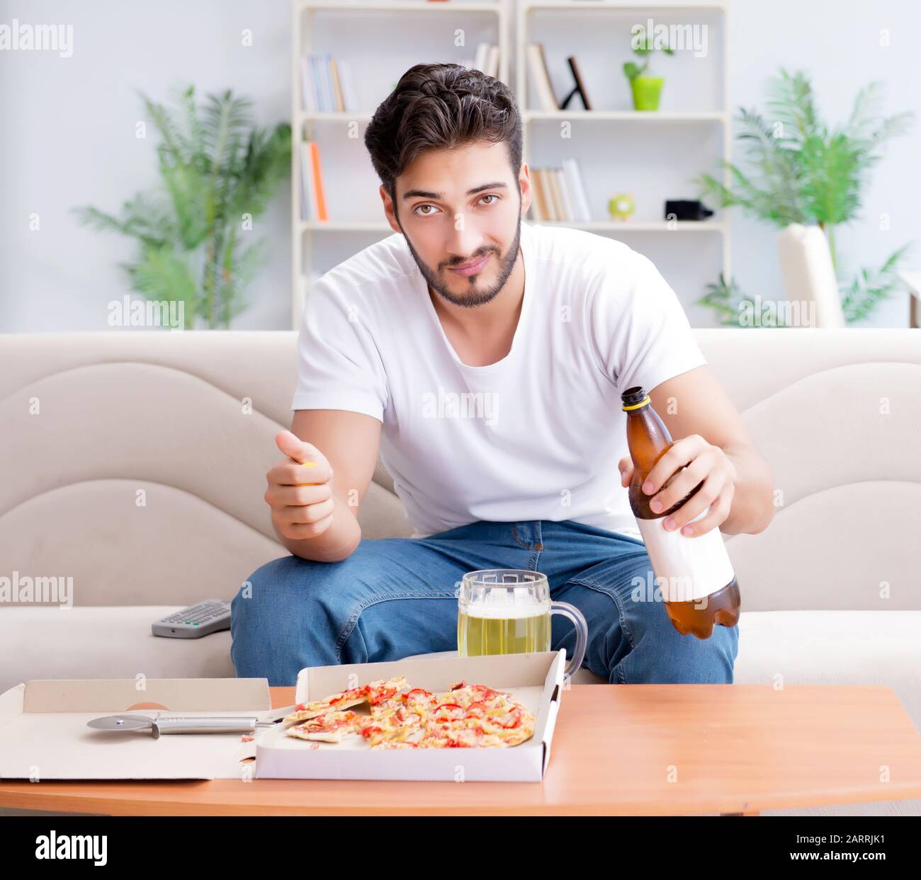 The man eating pizza having a takeaway at home relaxing resting Stock ...