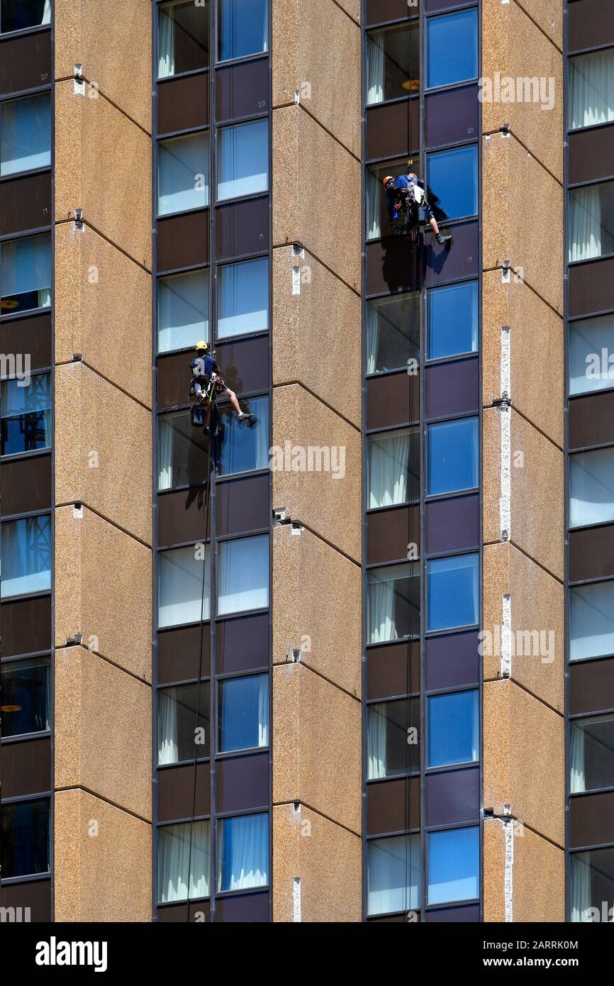 Australia, Sydney, two window cleaners working outside on office ...