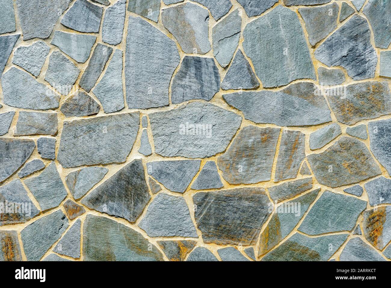 Wall pattern texture background. Surface with asymmetrical stones. Old ...