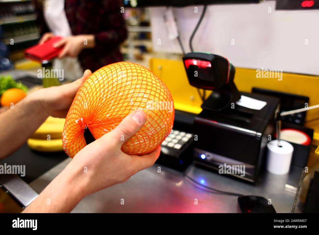 Male cashier checking out goods in supermarket Stock Photo - Alamy