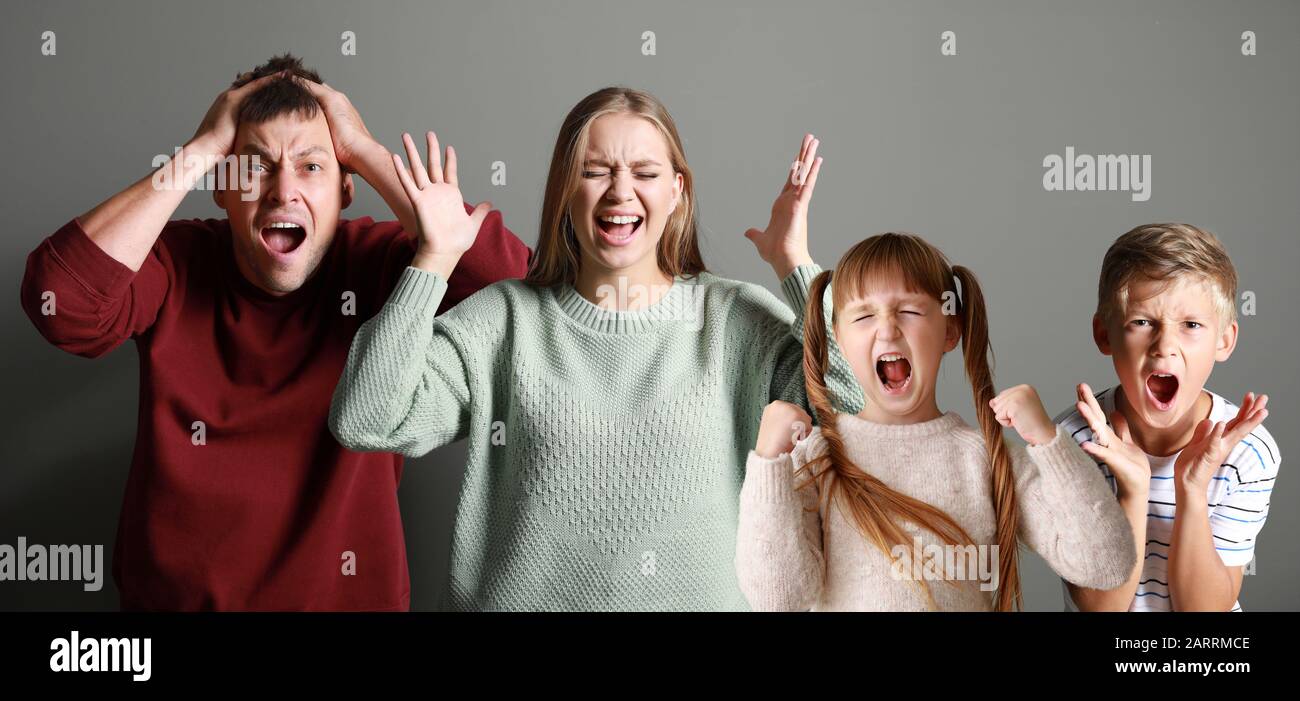 Portrait of angry family on grey background Stock Photo - Alamy