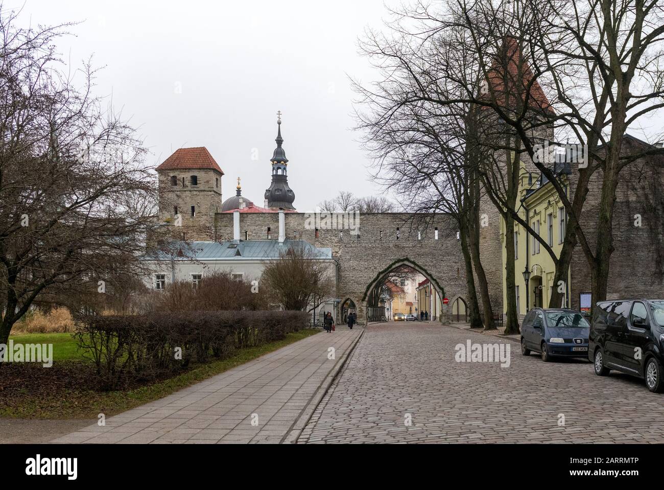 Road leading to arched gateway in medieval fortified wall, Tallinn ...