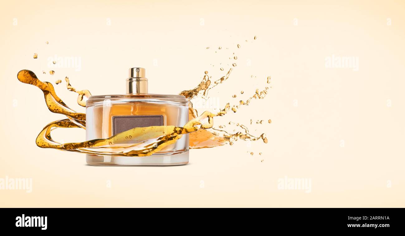 Bottle of perfume with splash on color background Stock Photo - Alamy