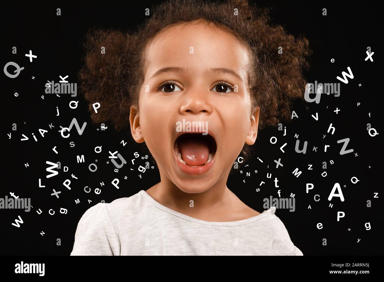 Screaming African-American girl and many letters on dark background ...