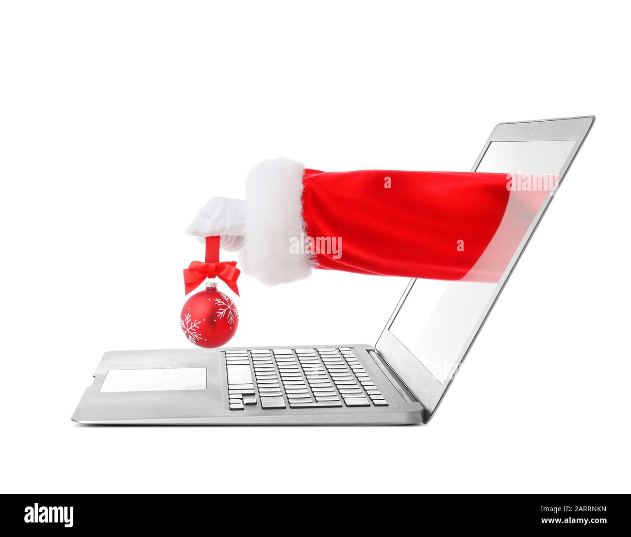 Santa sticking hand with Christmas ball out of laptop screen against ...