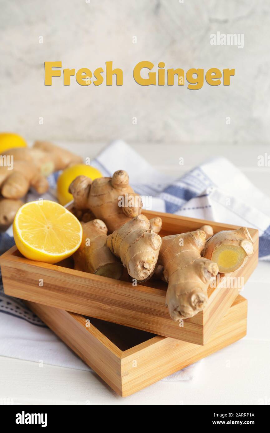 Fresh ginger with lemon on white table Stock Photo - Alamy