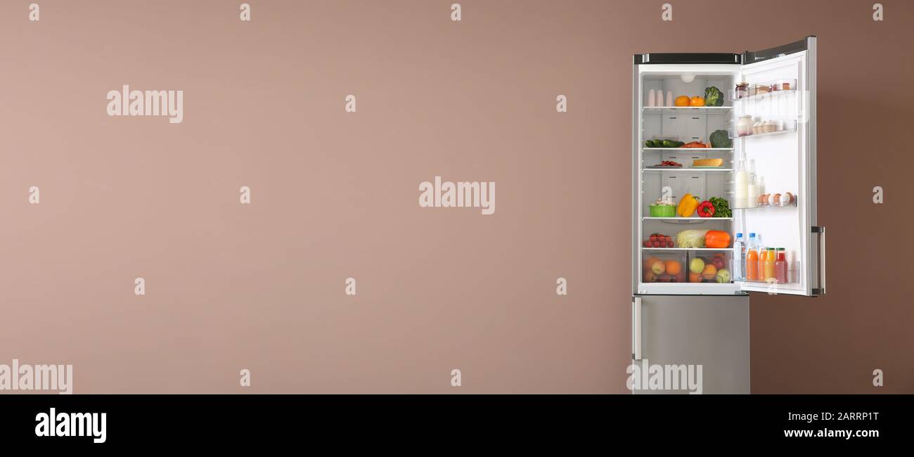 Open fridge full of food on color background with space for text Stock ...