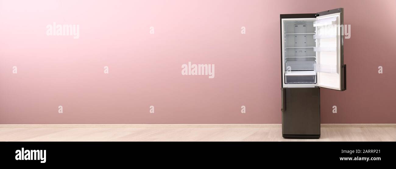 Big modern fridge near color wall Stock Photo - Alamy