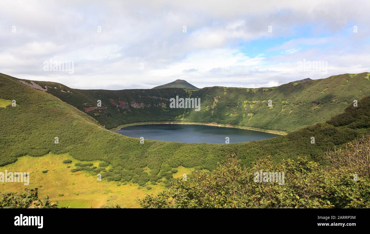 Small round lake inside the crater of the extinct volcano. Kamchatka ...