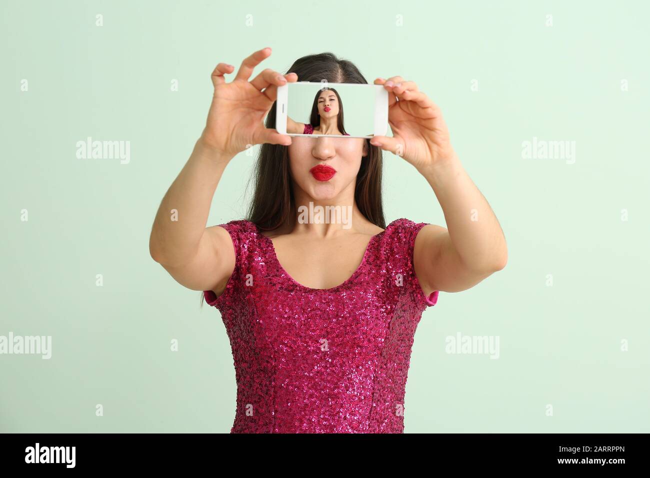 Beautiful woman taking selfie on color background Stock Photo - Alamy