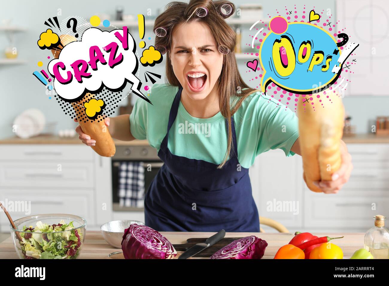 Aggressive young housewife in kitchen Stock Photo - Alamy