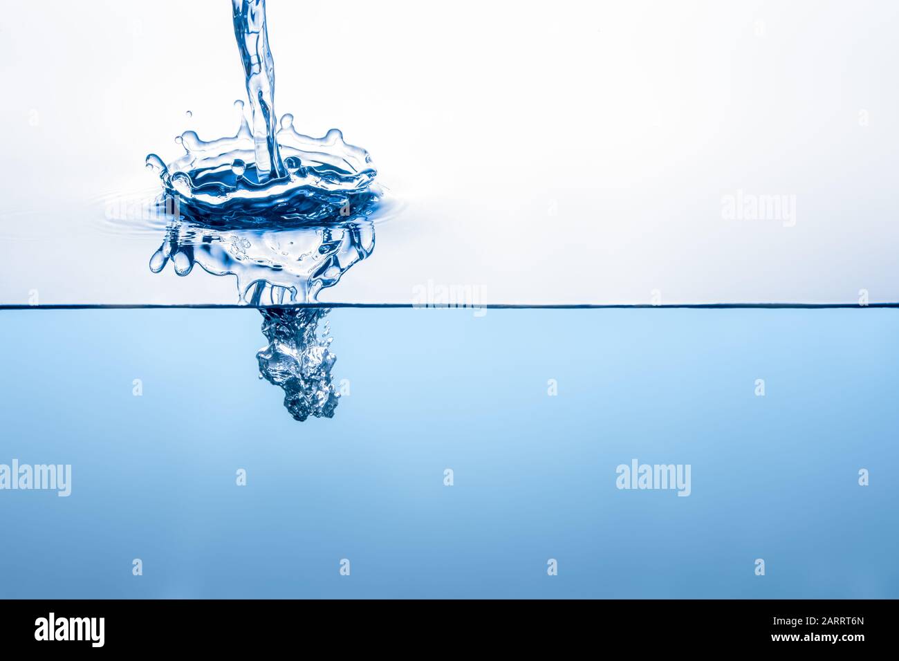 Stream of water creating a splash on the surface and continues ...