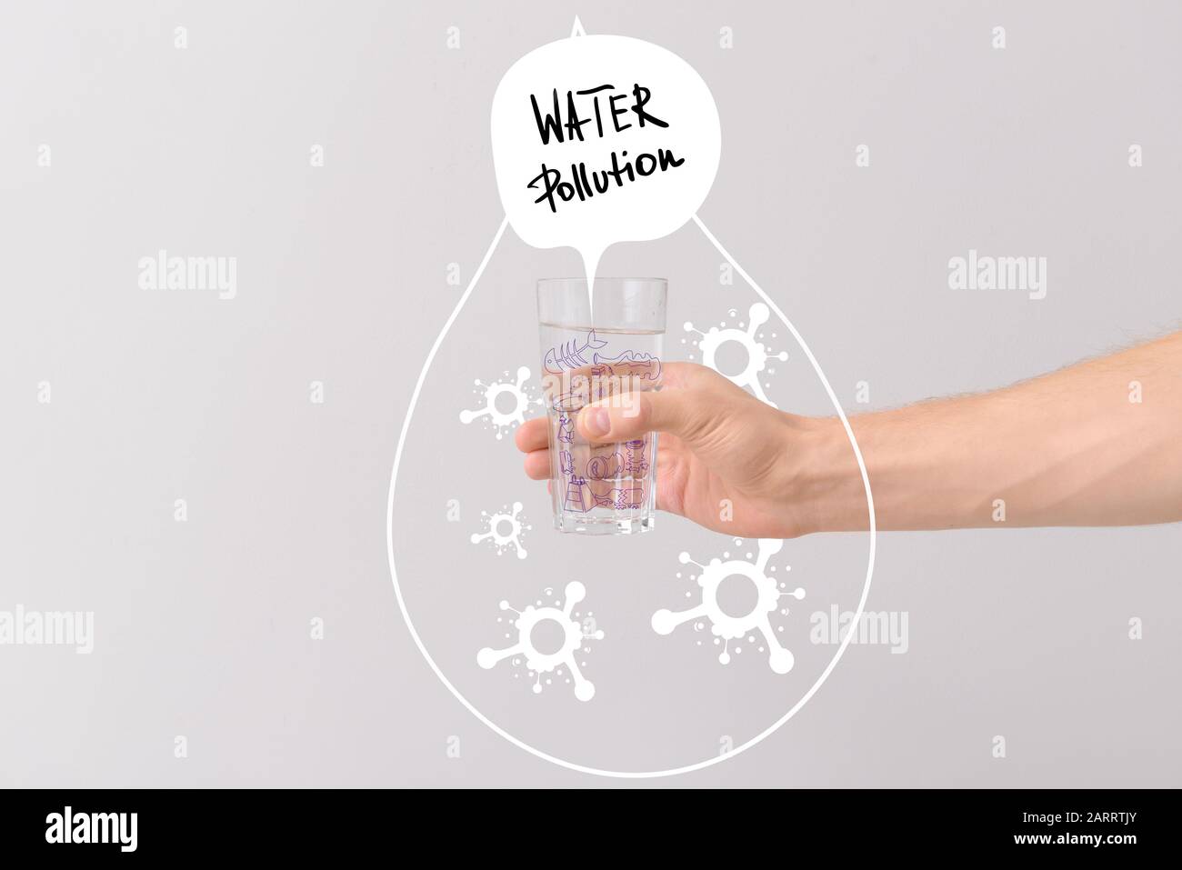 Male hand with glass of water and drawn drop with microbes on light ...